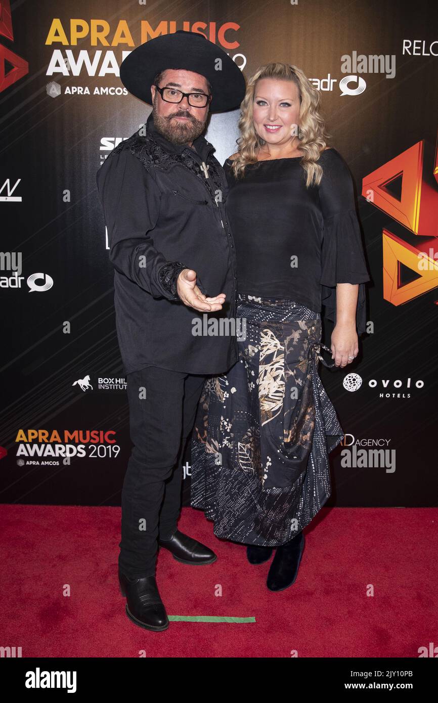 Andrew Farriss and his wife Marlina pose for a photograph on the red ...