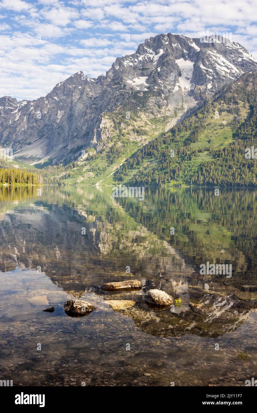 Mount Moran rising high above a small collection of rocks in the ...