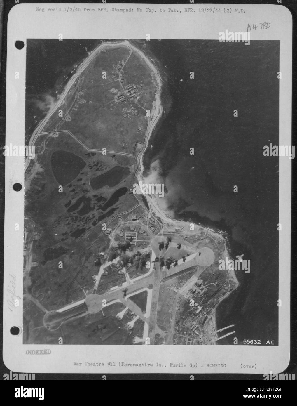 A string of bombs from an 11th Air force Liberator explode along the ...