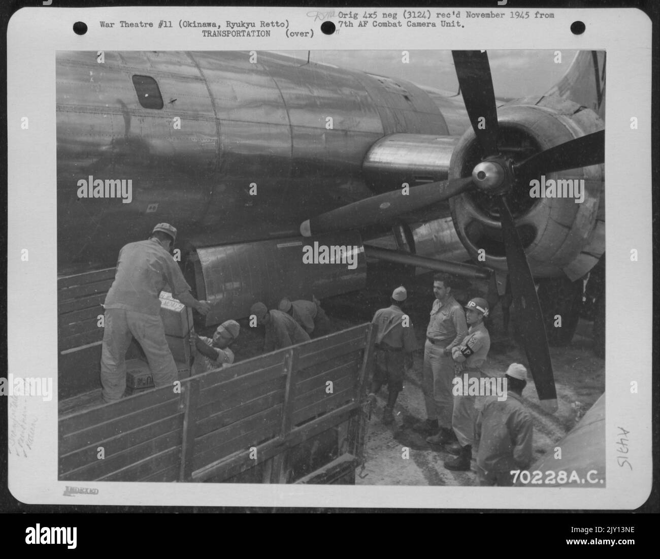 An M.P. Stands Nearby As Japaneseanese Prisoners Of War Load Food ...