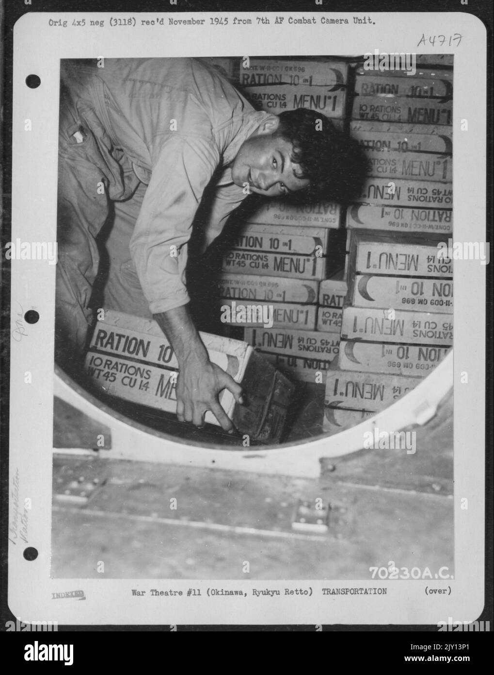 A G.I. Of The 7Th Air Force Unloads Rations From A Boeing B-29 Bomb Bay ...
