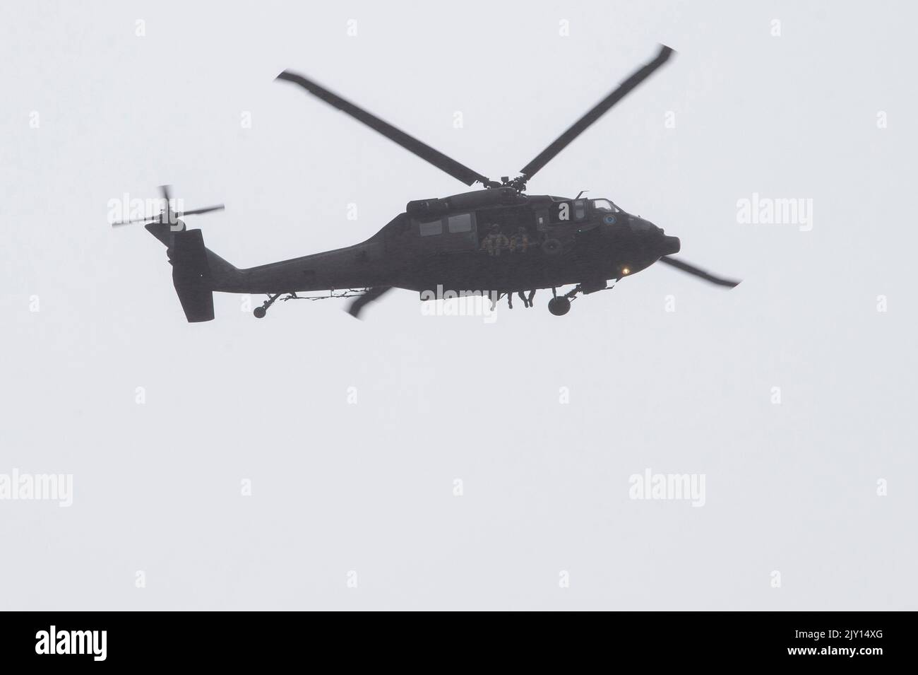 An Alaska Army National Guard UH-60L Black Hawk helicopter passes over ...