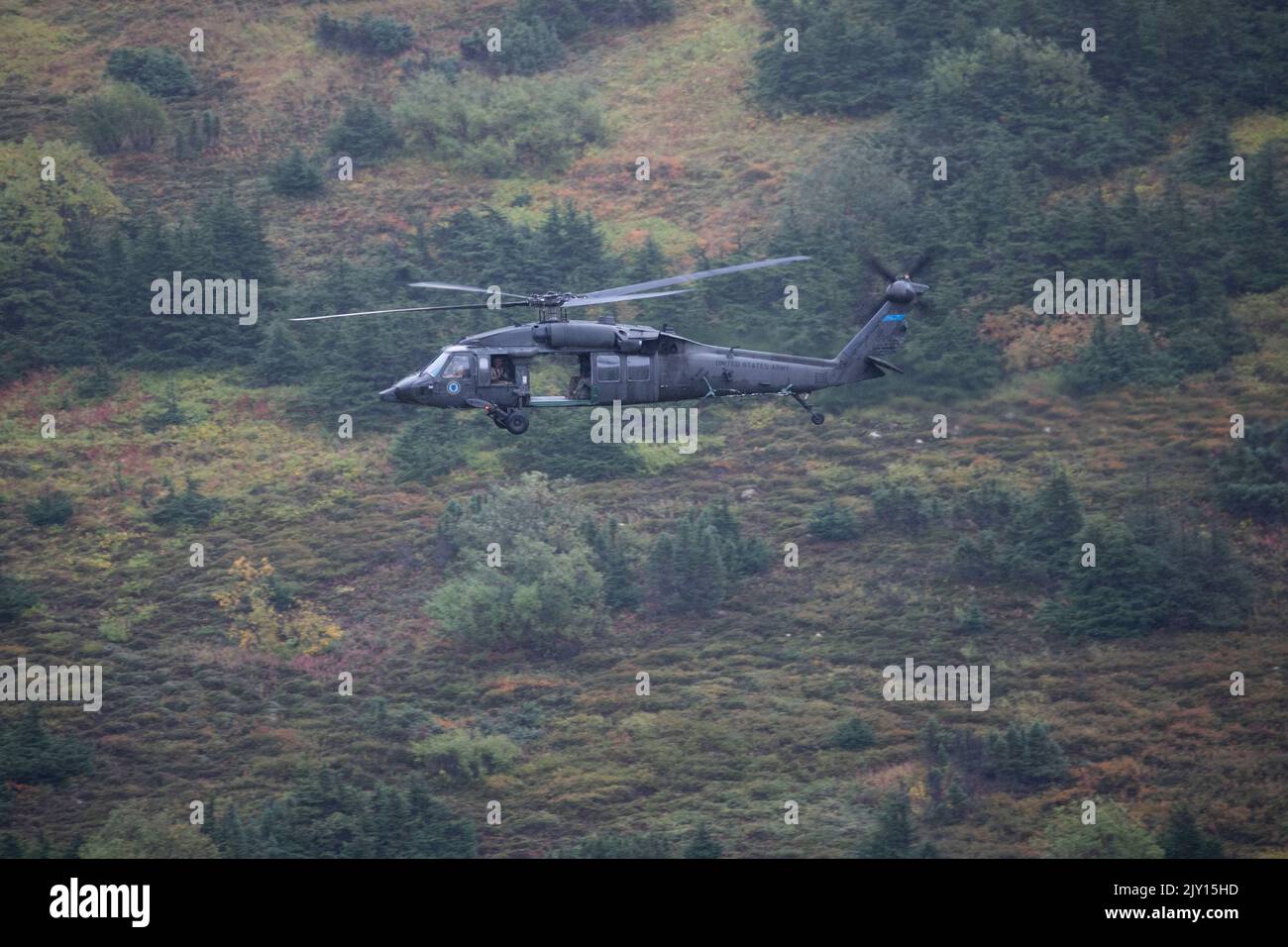 An Alaska Army National Guard UH-60L Black Hawk helicopter passes over ...