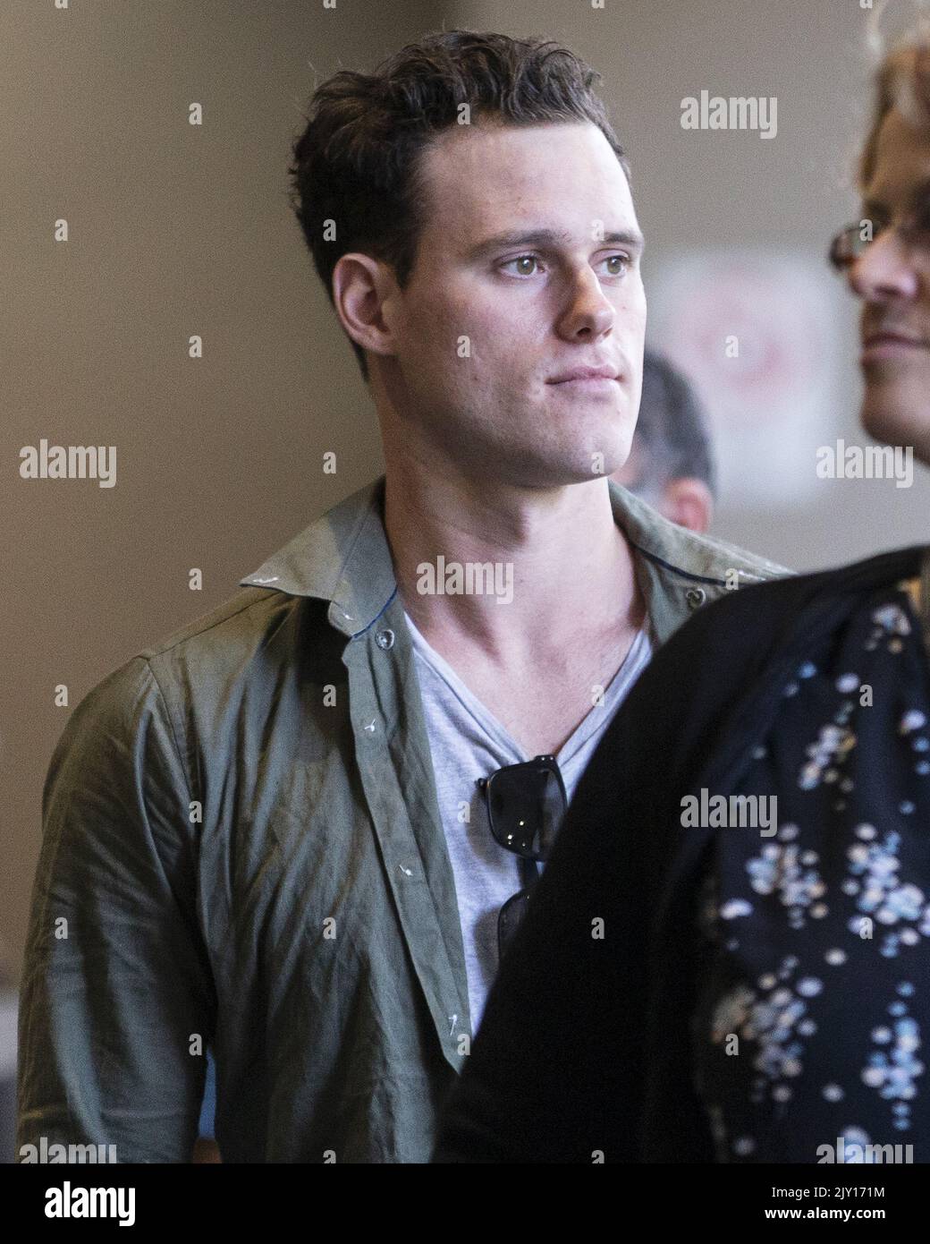 Joshua Burke (centre) arrives at the Melbourne Magistrates Court in ...