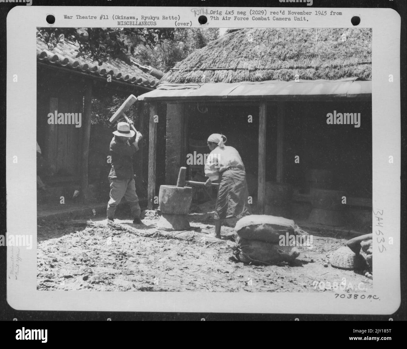 Natives Pound Rice Into Flour At A Rice Mill On Okinawa, Ryukyu Retto ...