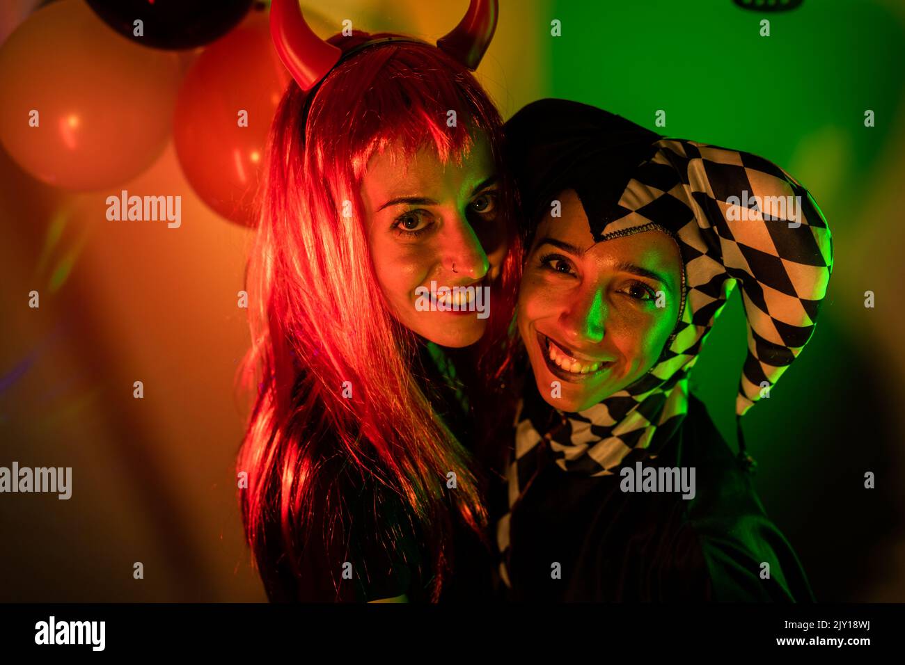 Friends in costume smiling in a halloween indoor party Stock Photo - Alamy
