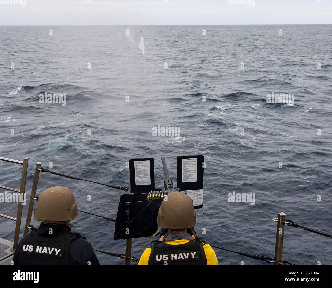 U.S. Navy Sailors assigned to USS New Orleans (LPD 18) fire an M2 .50 ...
