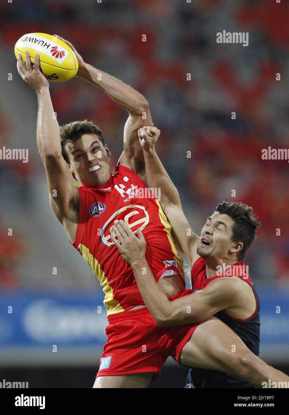 Jack Bowes (left) of the Suns marks over Jay Lockhart of Demons during ...