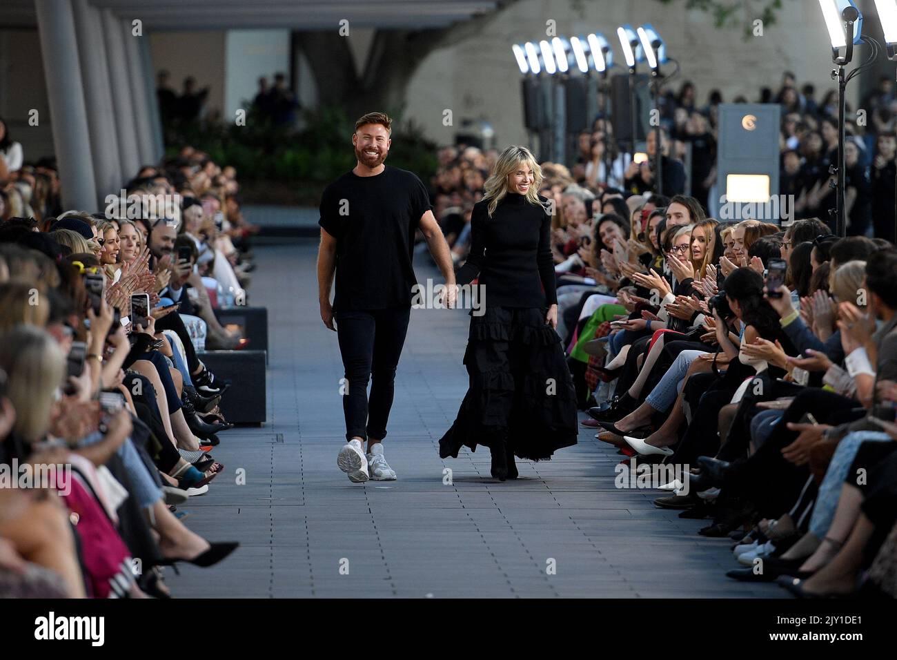 Aje designers Adrian Norris and Edwina Forrest gesture following their ...