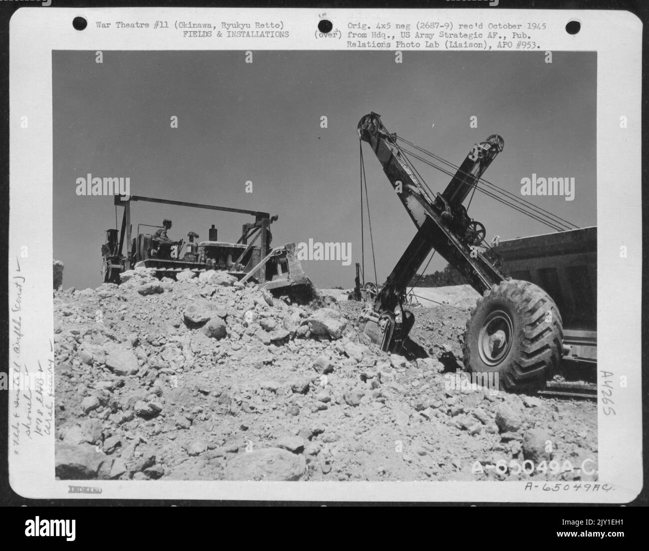 A Bulldozer Pushes Coral Into Steam Shovel's Large Dipper At Quarry On Okinawa, Ryukyu Retto ...