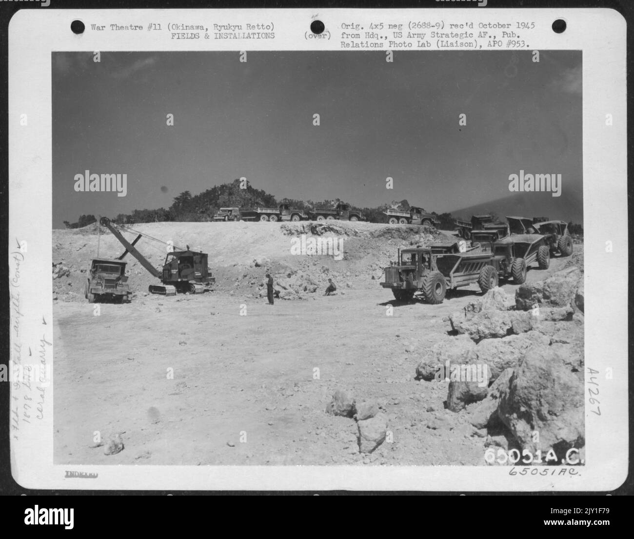 A Line Of Trucks And Tournatrailers Await Their Turn To Receive Load Of ...