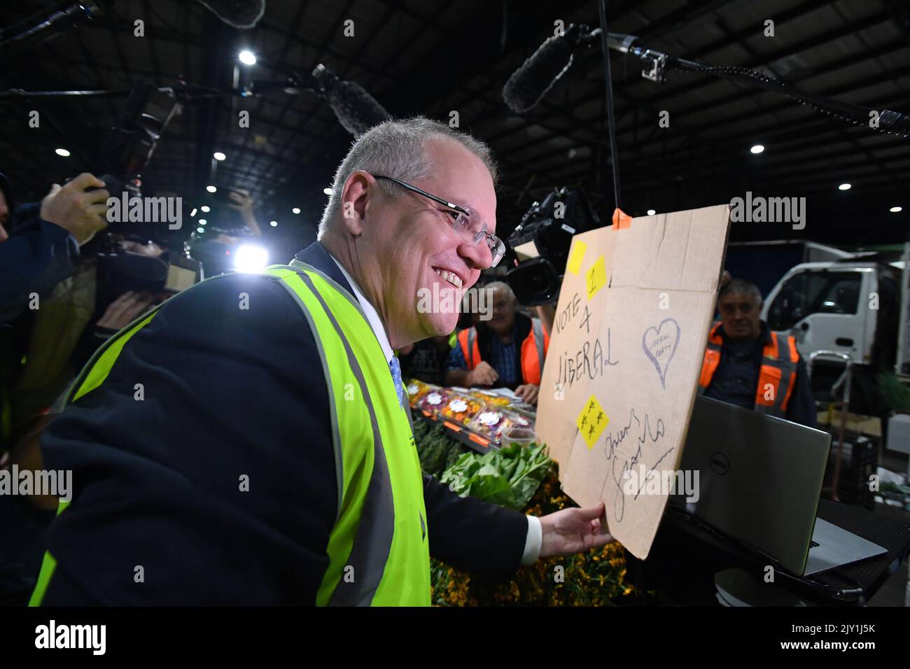 Prime Minister Scott Morrison signs his name on a sign during a visit ...