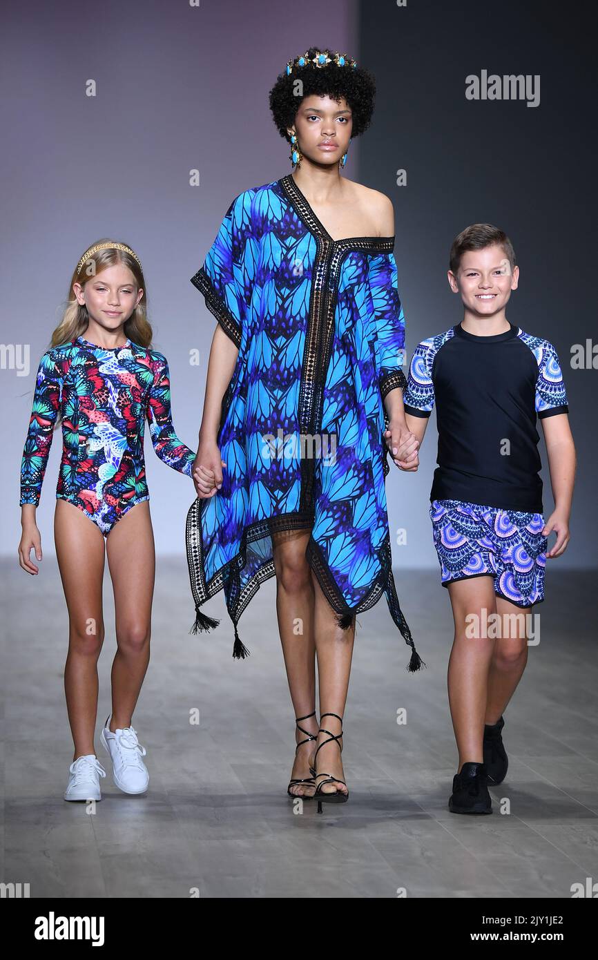 A model walks the runway wearing creations by Aqua Blu during Mercedes ...