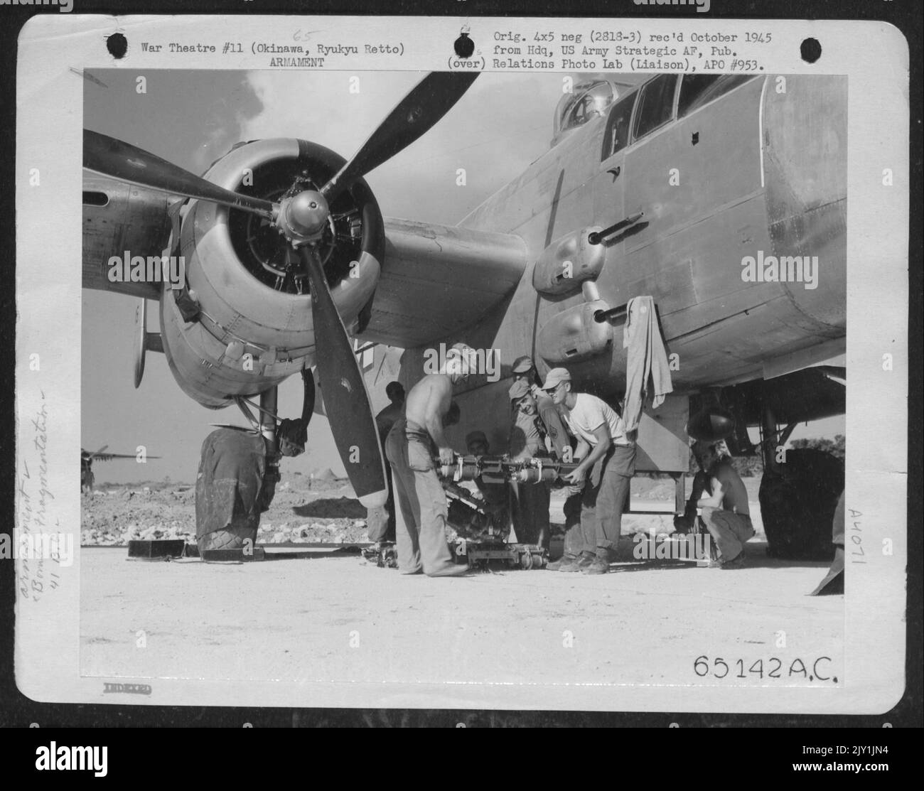 Armorers Load Clusters Of Fragmentation Bombs On A North American B-25 ...