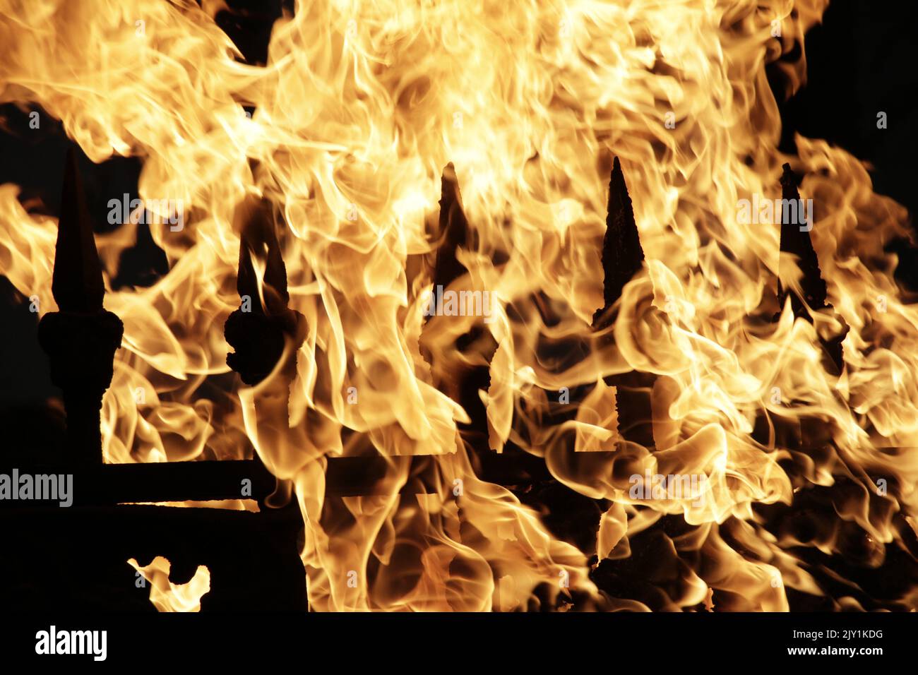 Metal fence on fire. The process of burning old paint on a metal ...