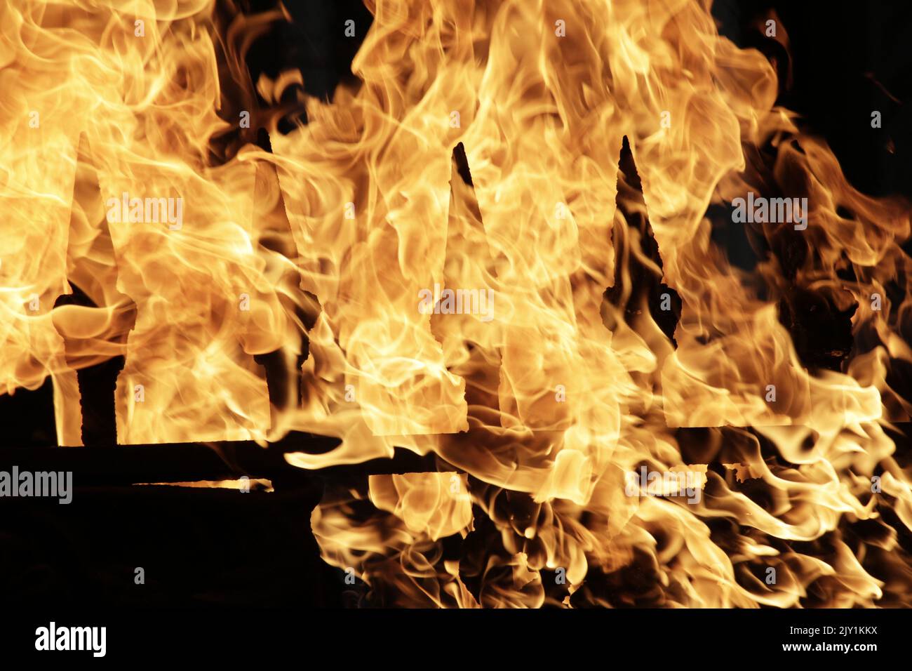 Metal fence on fire. The process of burning old paint on a metal ...