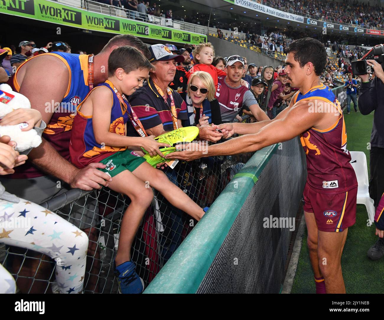 Charlie Cameron (right) of the Lions gives his boots to a fan after ...