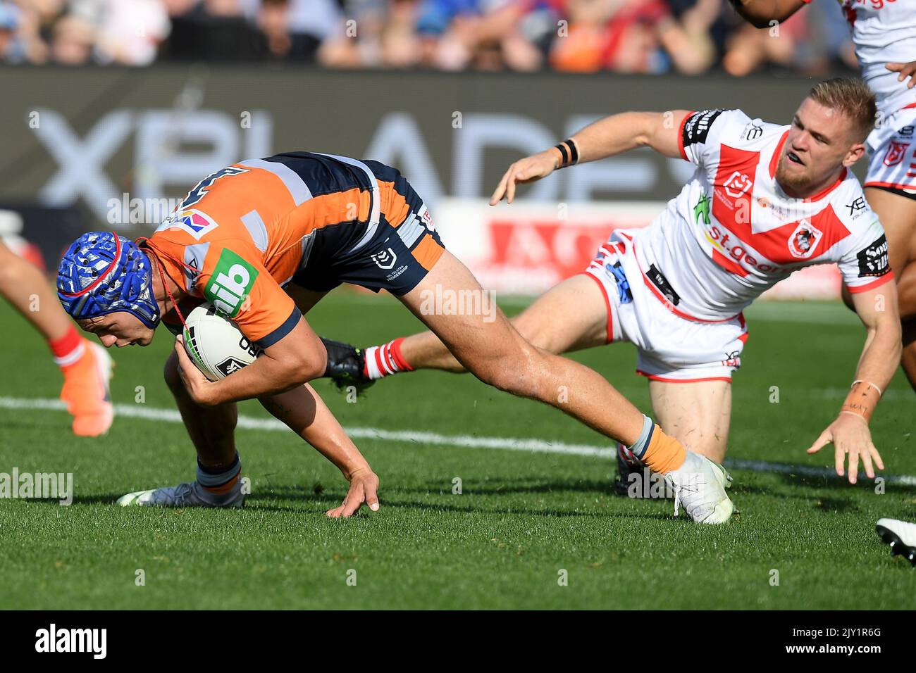 Kalyn Ponga of the Knights evades a tackle from Matt Dufty of the ...