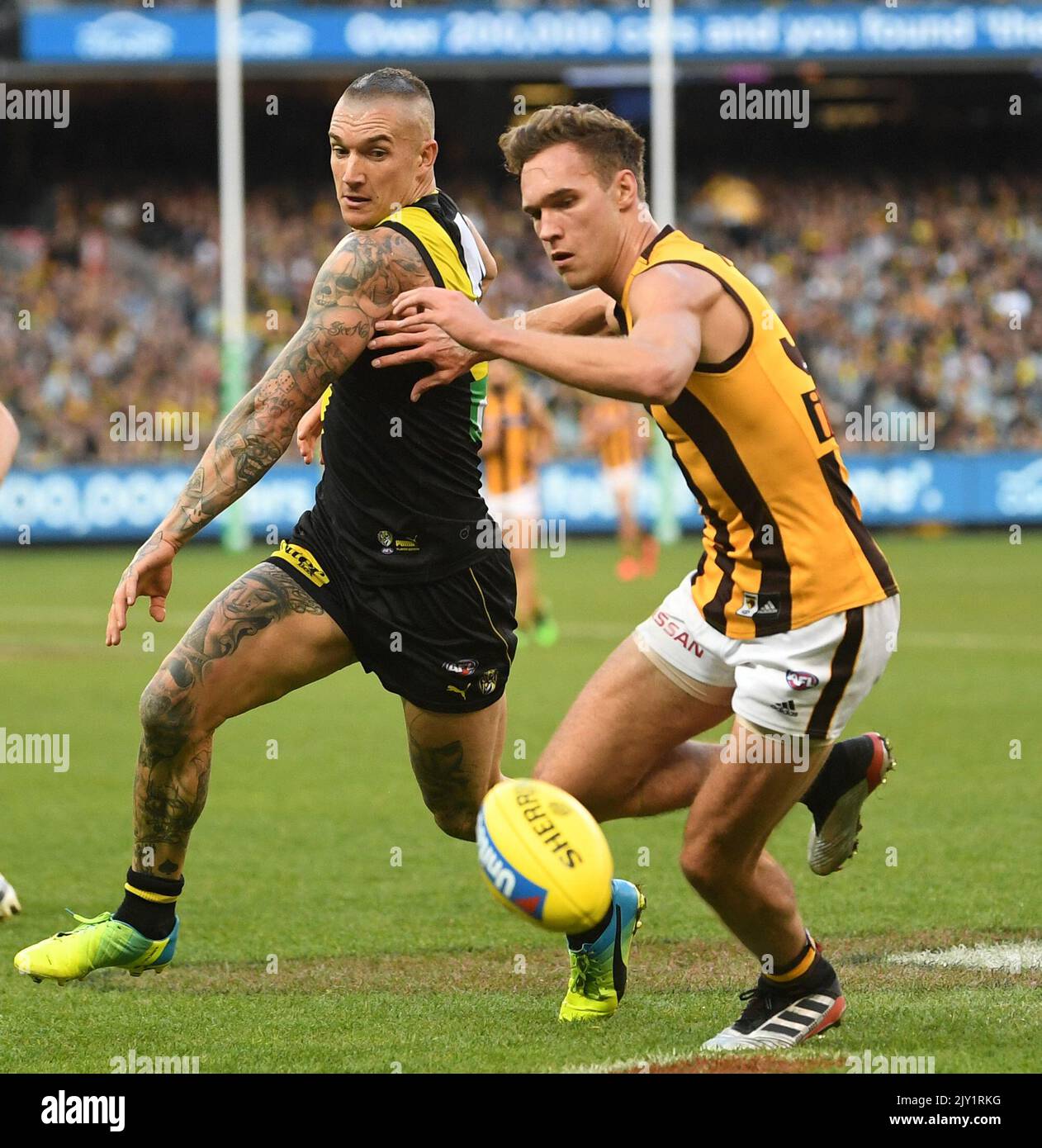 Dustin Martin of the Tigers (left) and Jack Scrimshaw of the Hawks ...