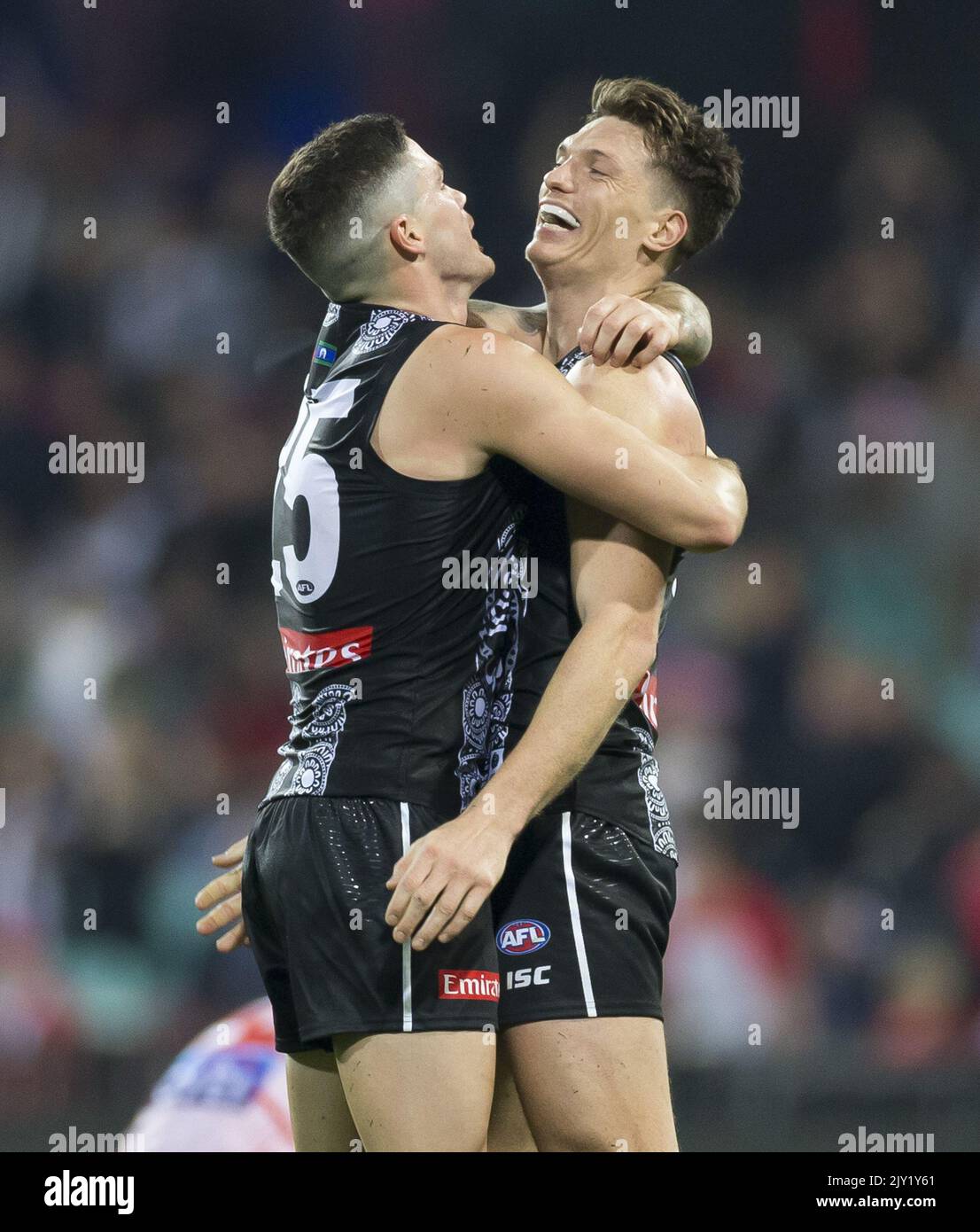Jack Crisp (left) and Brody Mihocek of the Magpies hug at full time ...
