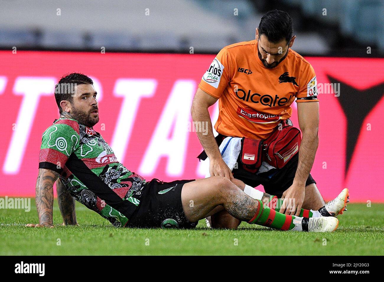 Adam Reynolds of the Rabbitohs receives attention from a trainer during ...