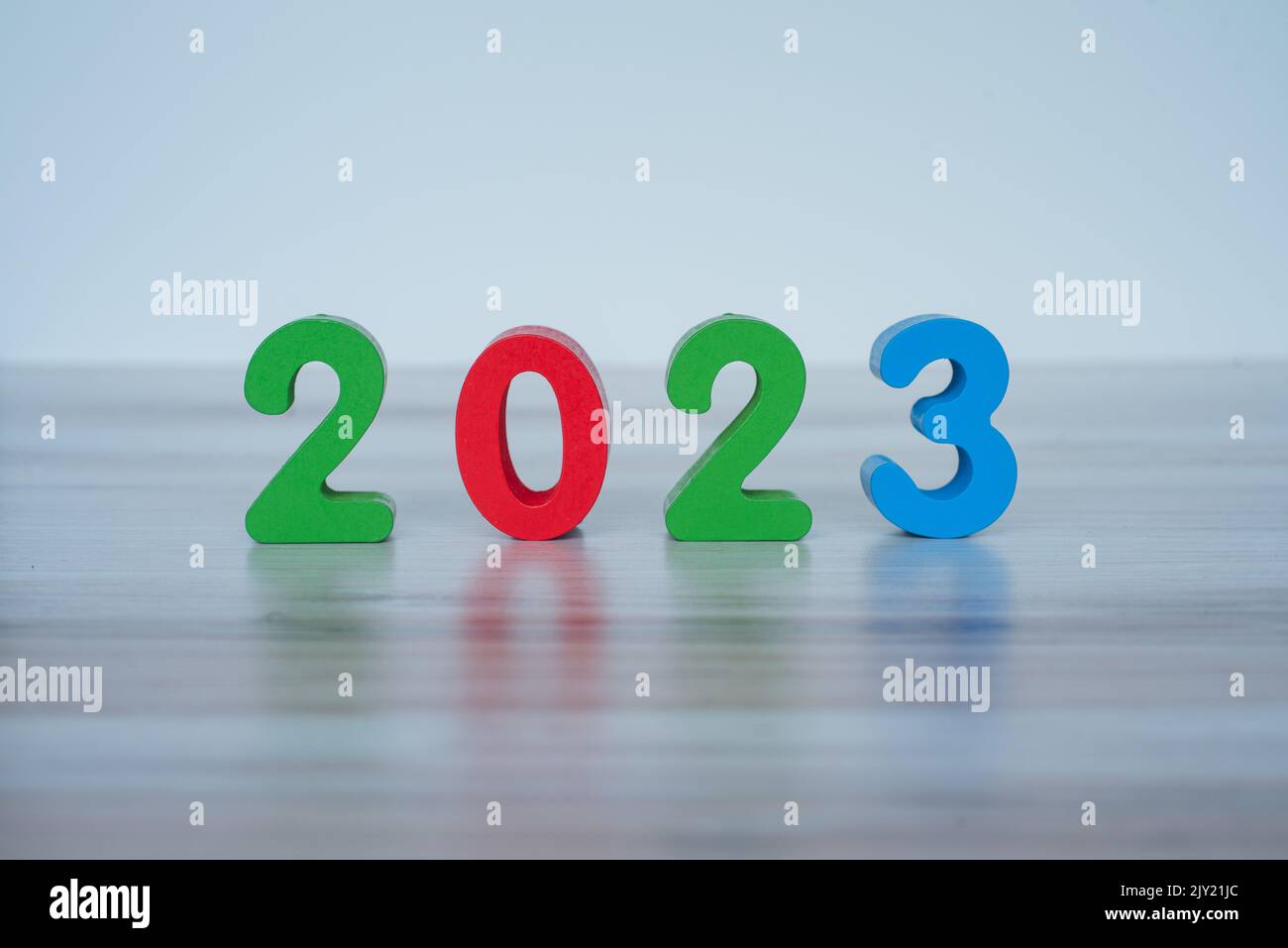 2023 standing colored block numbers on light wooden and white ...