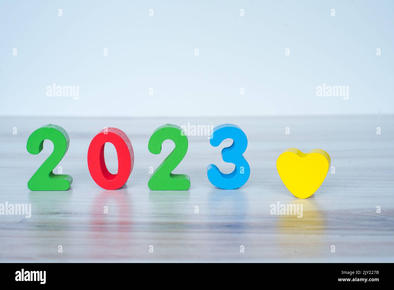 2023 standing colored block numbers on light wooden and white ...