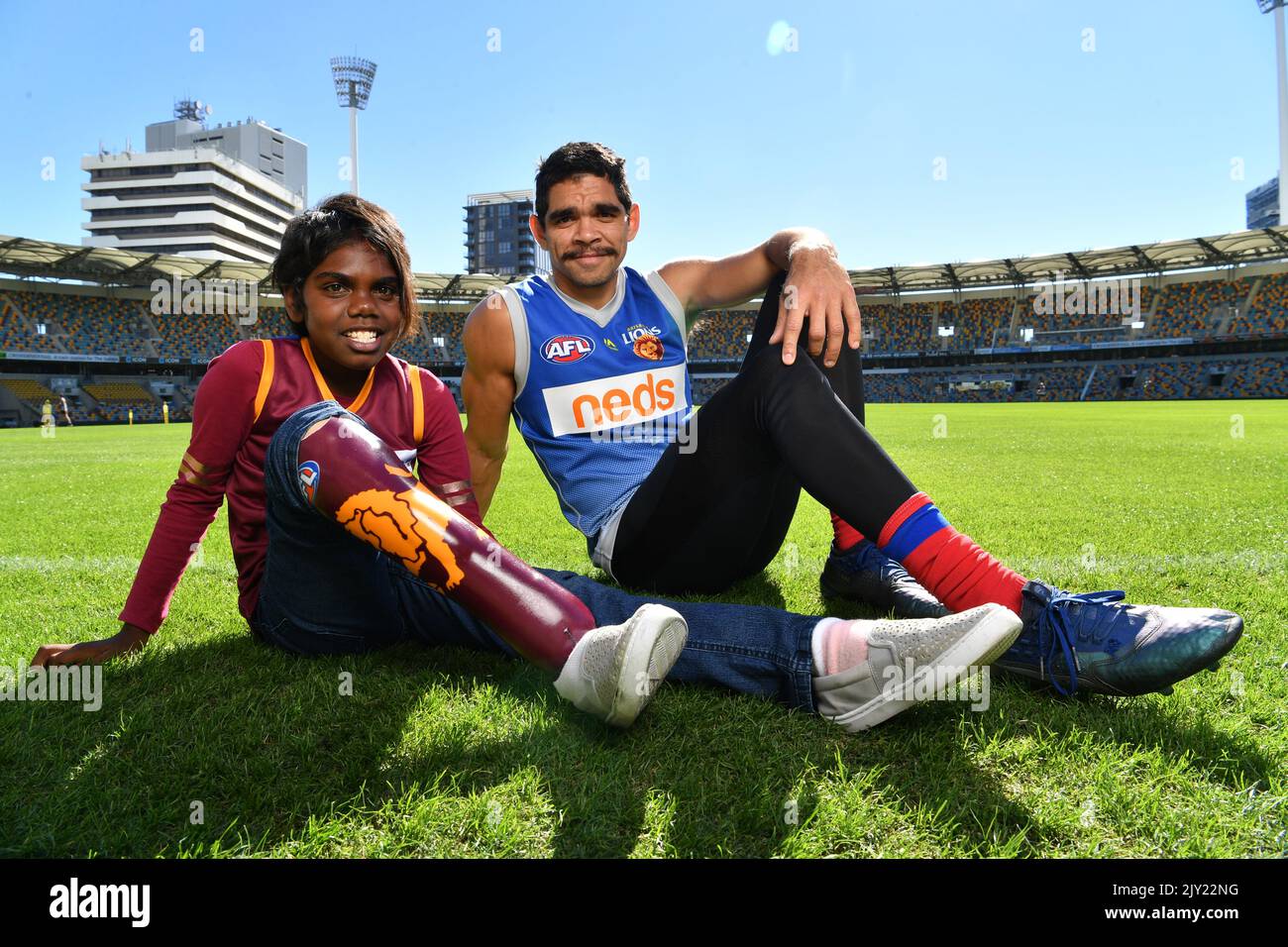 Shericka Mahoney (left) is seen with Lions player Charlie Cameron ...