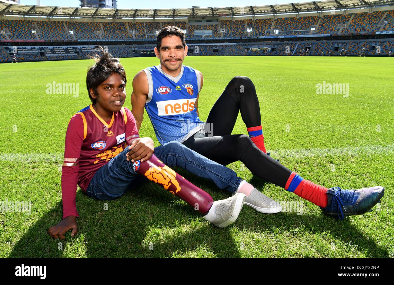 Shericka Mahoney (left) is seen with Lions player Charlie Cameron ...