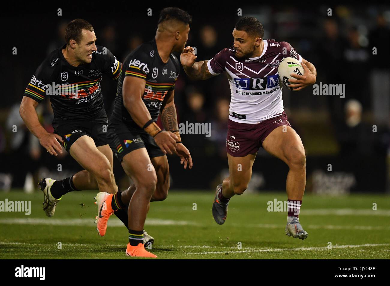 Dylan Walker of the Sea Eagles fends off Isaah Yeo of the Panthers ...