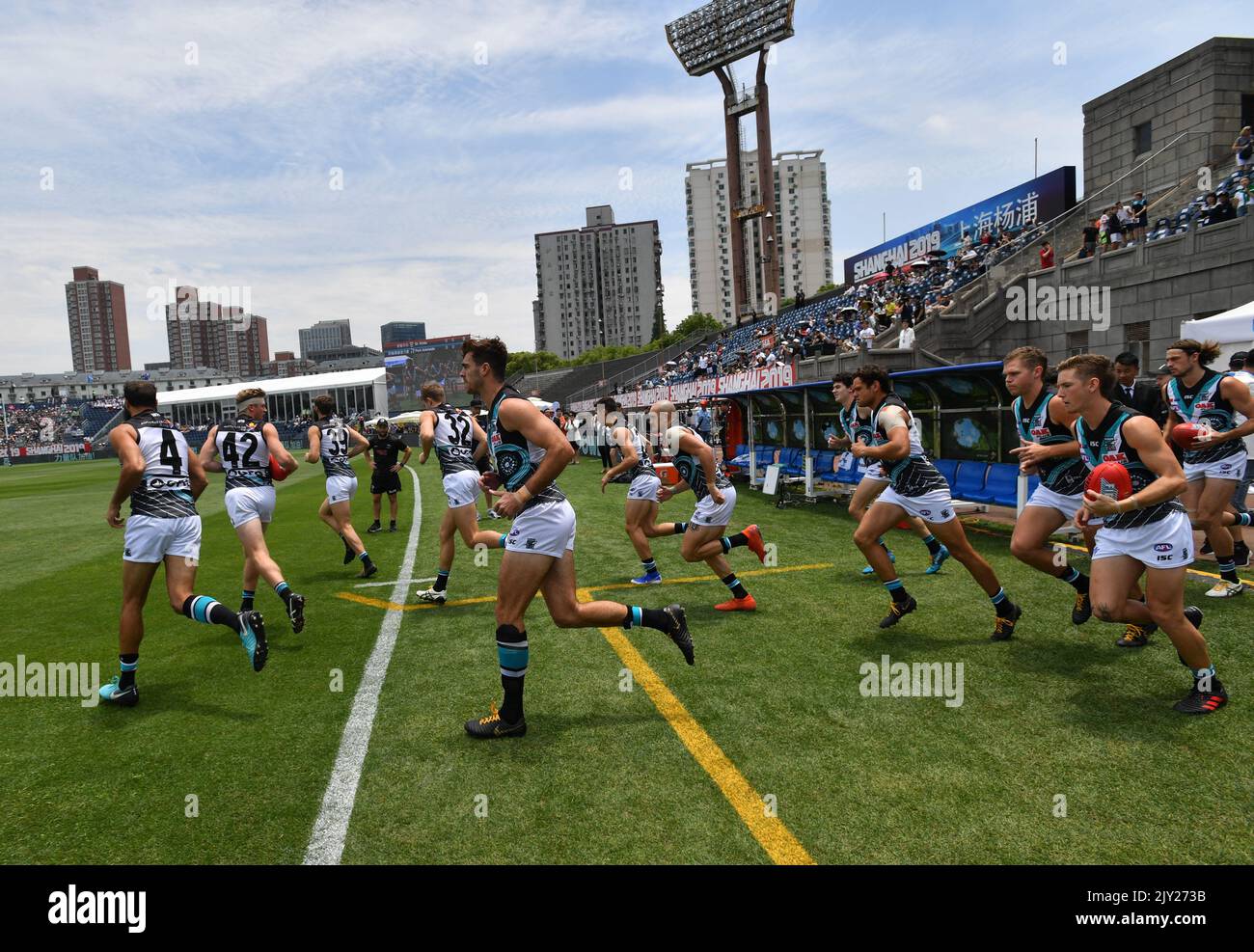 Power players run onto the field during the Round 11 AFL match between ...