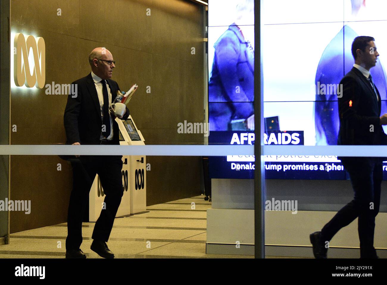 Australian Federal Police (AFP) investigators leave the main entrance ...