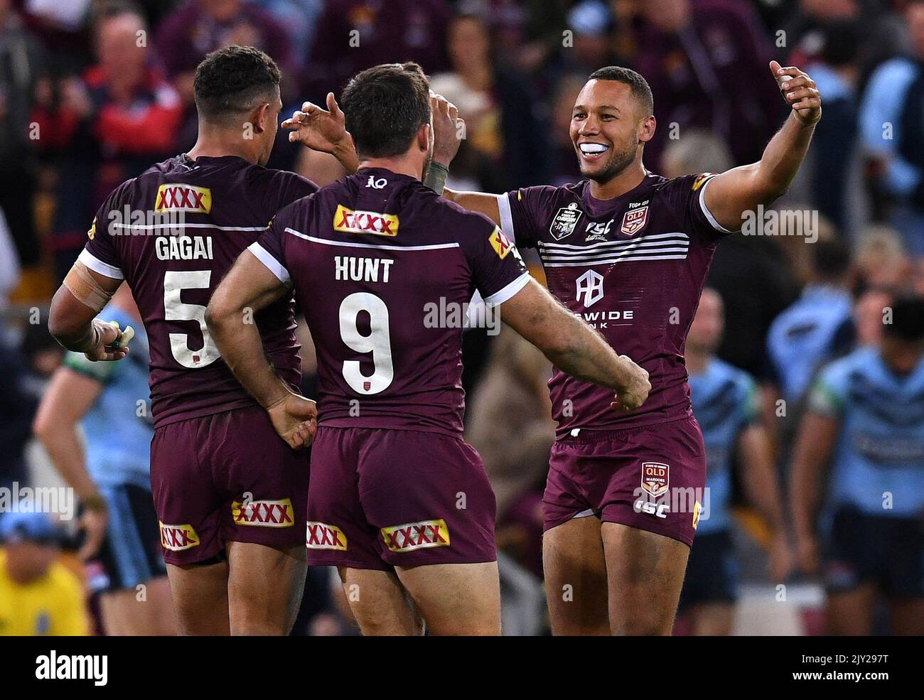 Moses Mbye of the Maroons (right) celebrates with teammates winning ...