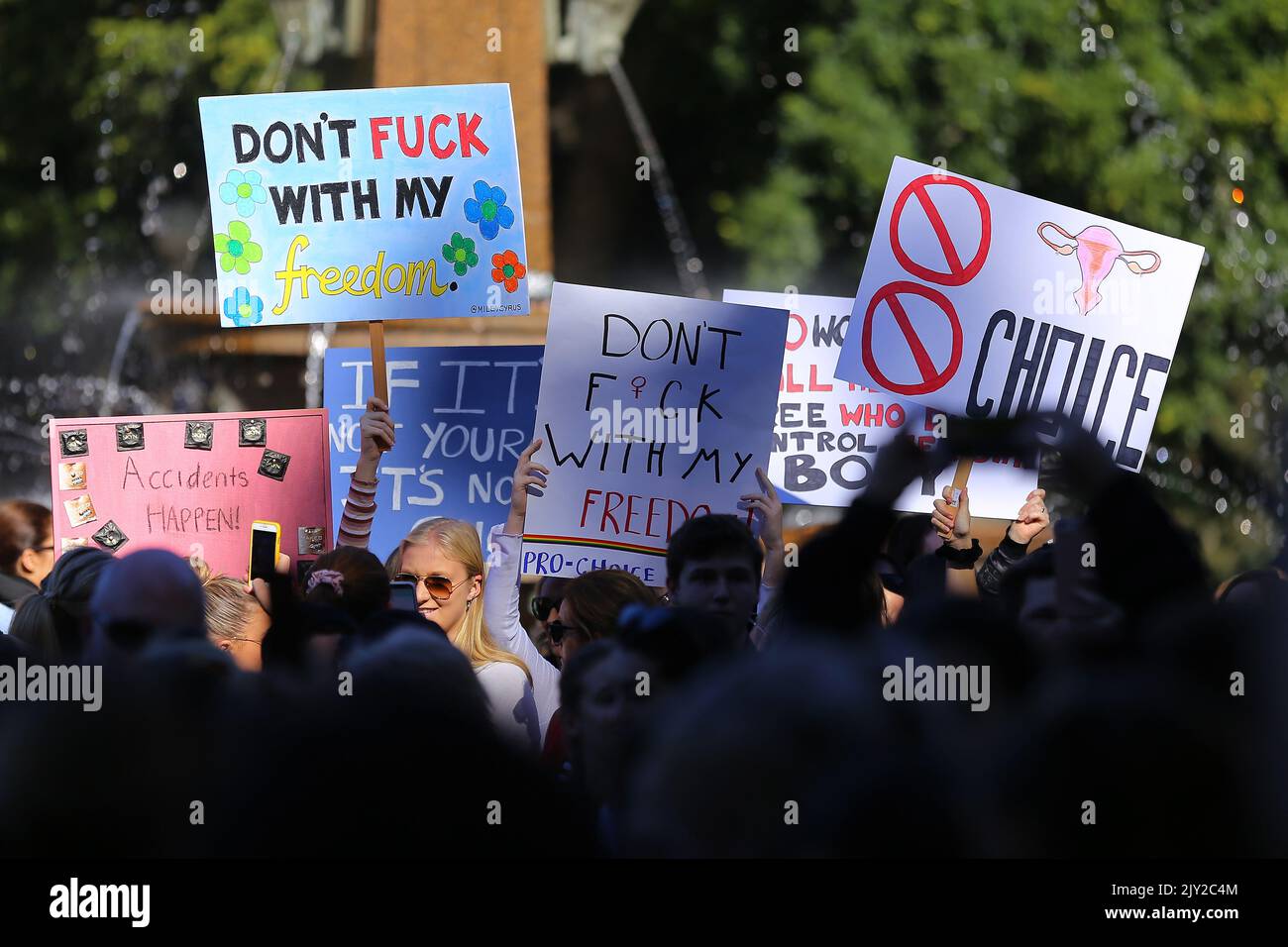 Protesters hold placards during the Our Body Our Choice march in Sydney ...
