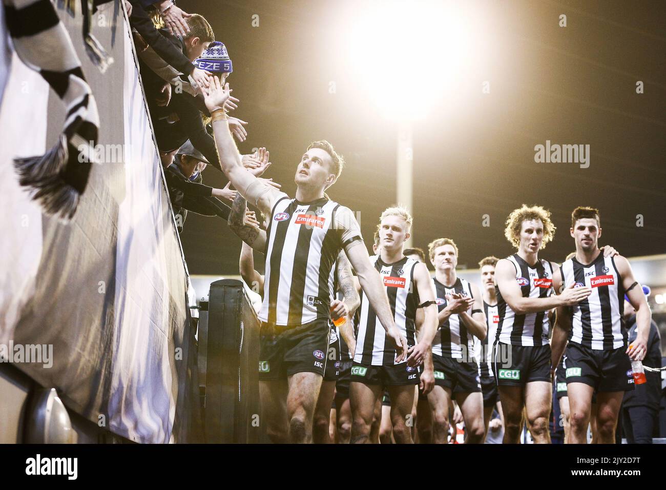 Jordan Roughead of the Magpies leads the Magpies off the ground after ...