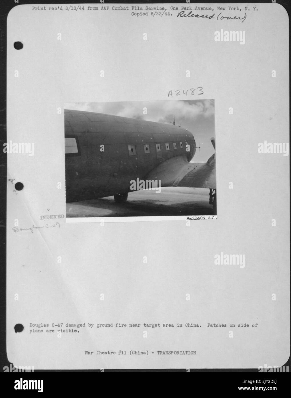 Douglas C-47 damaged by ground fire near target area in China. Patches on side of plane are ...