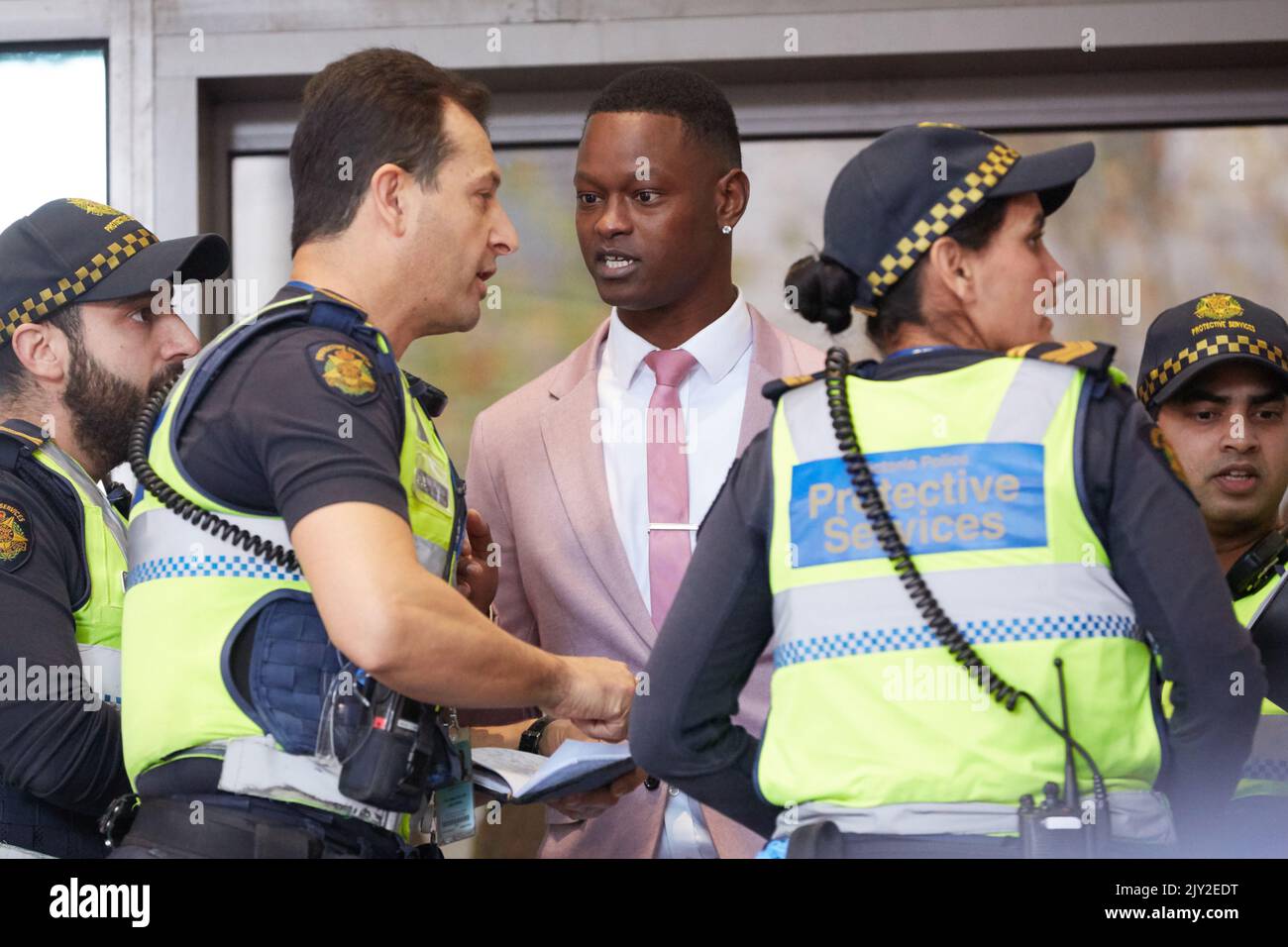 Protective Service Officers speak to Nelly Yoa as he arrives at the ...