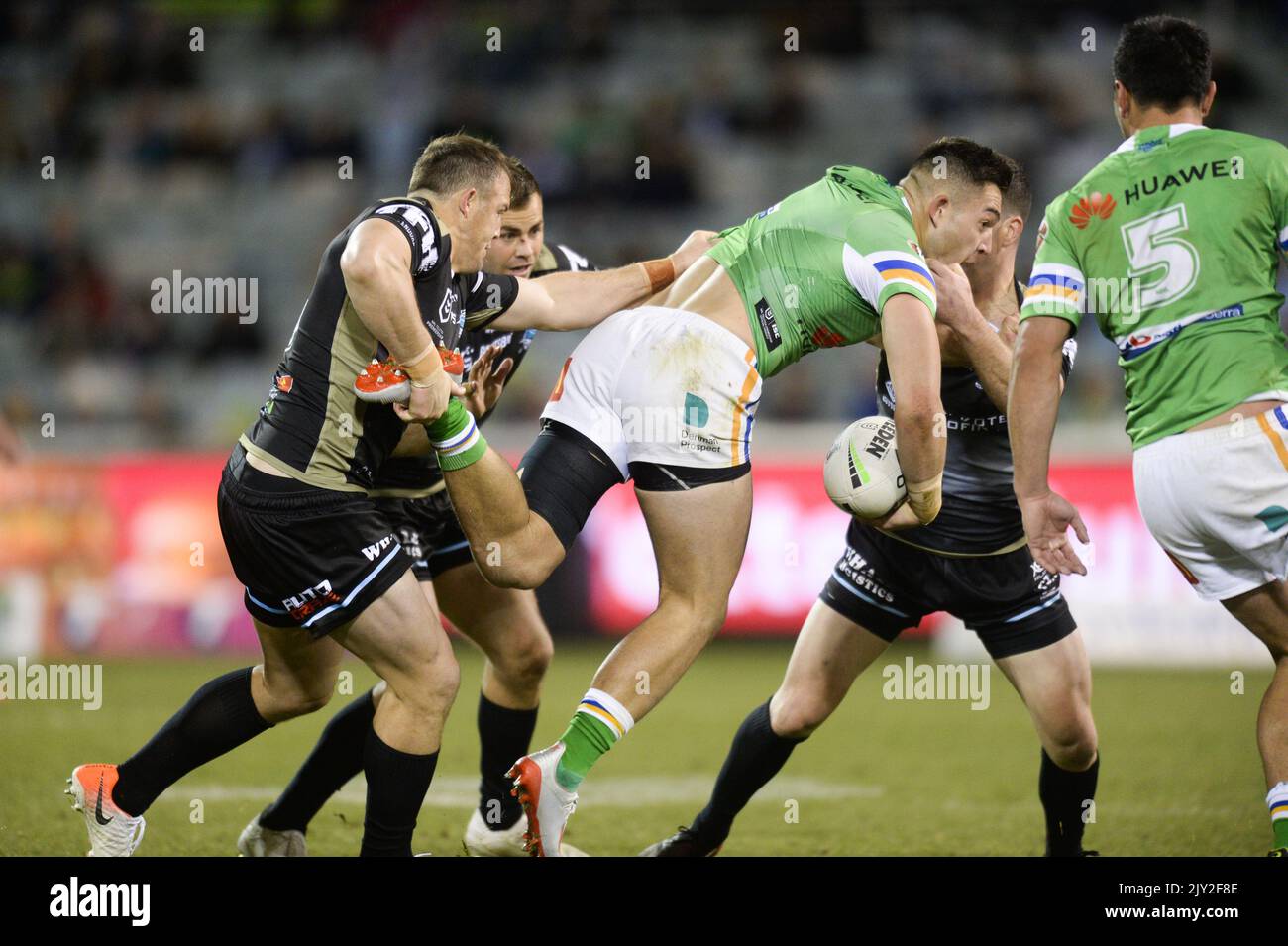 Josh Morris of the Sharks holds the leg of Nick Cotric of the Raiders ...