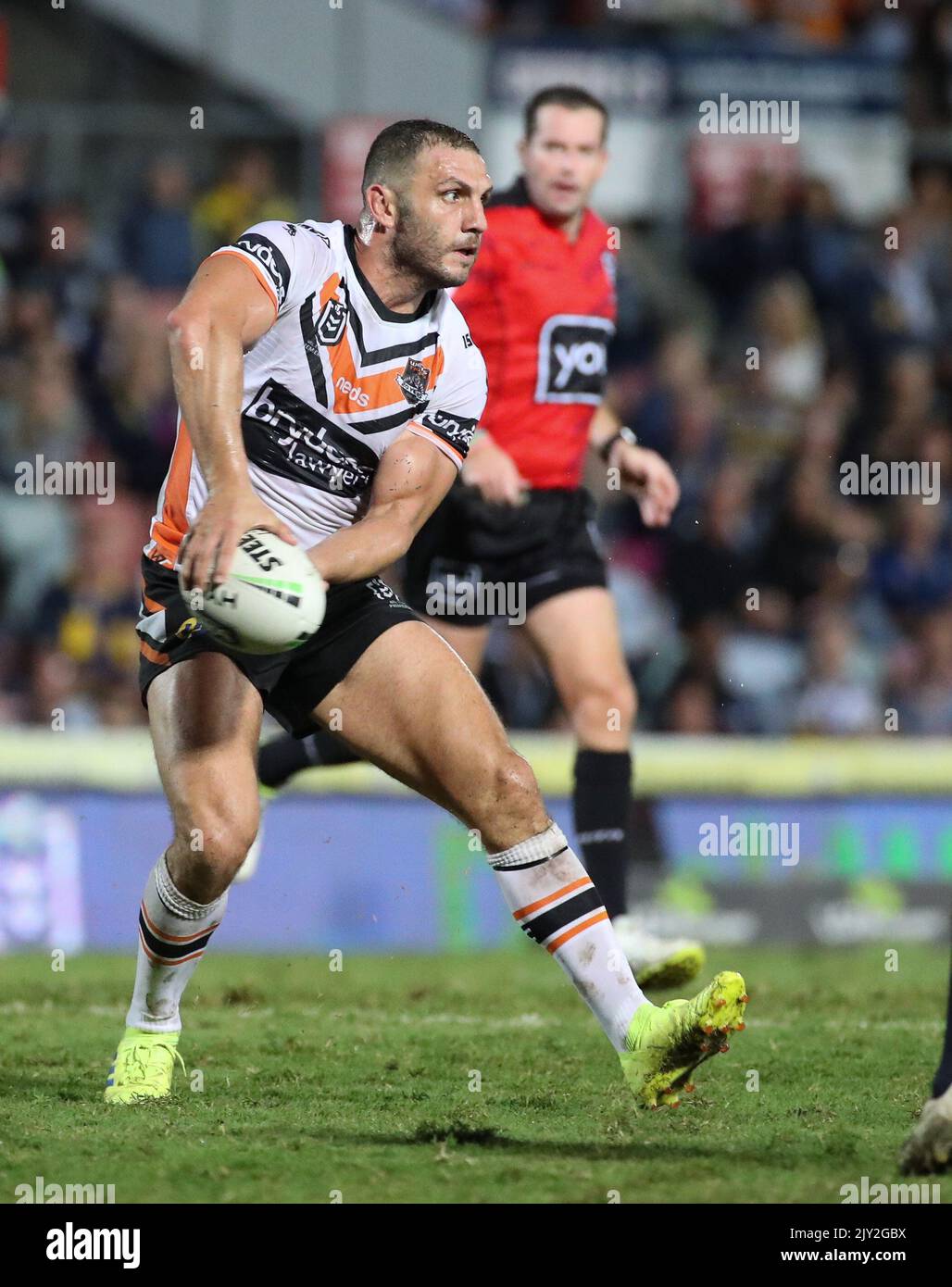 Robbie Farah of the Tigers looks to pass the ball during the Round 14 ...