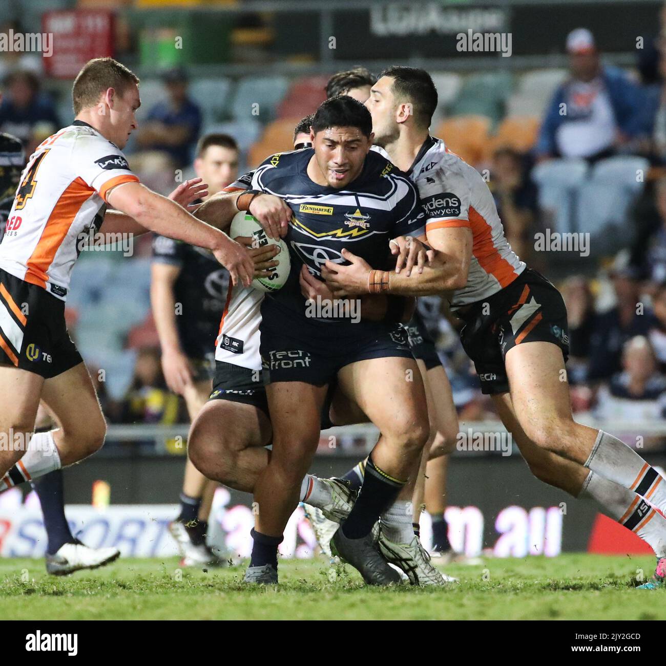 Jason Taumalolo of the Cowboys is tackled by Tigers defence during the ...