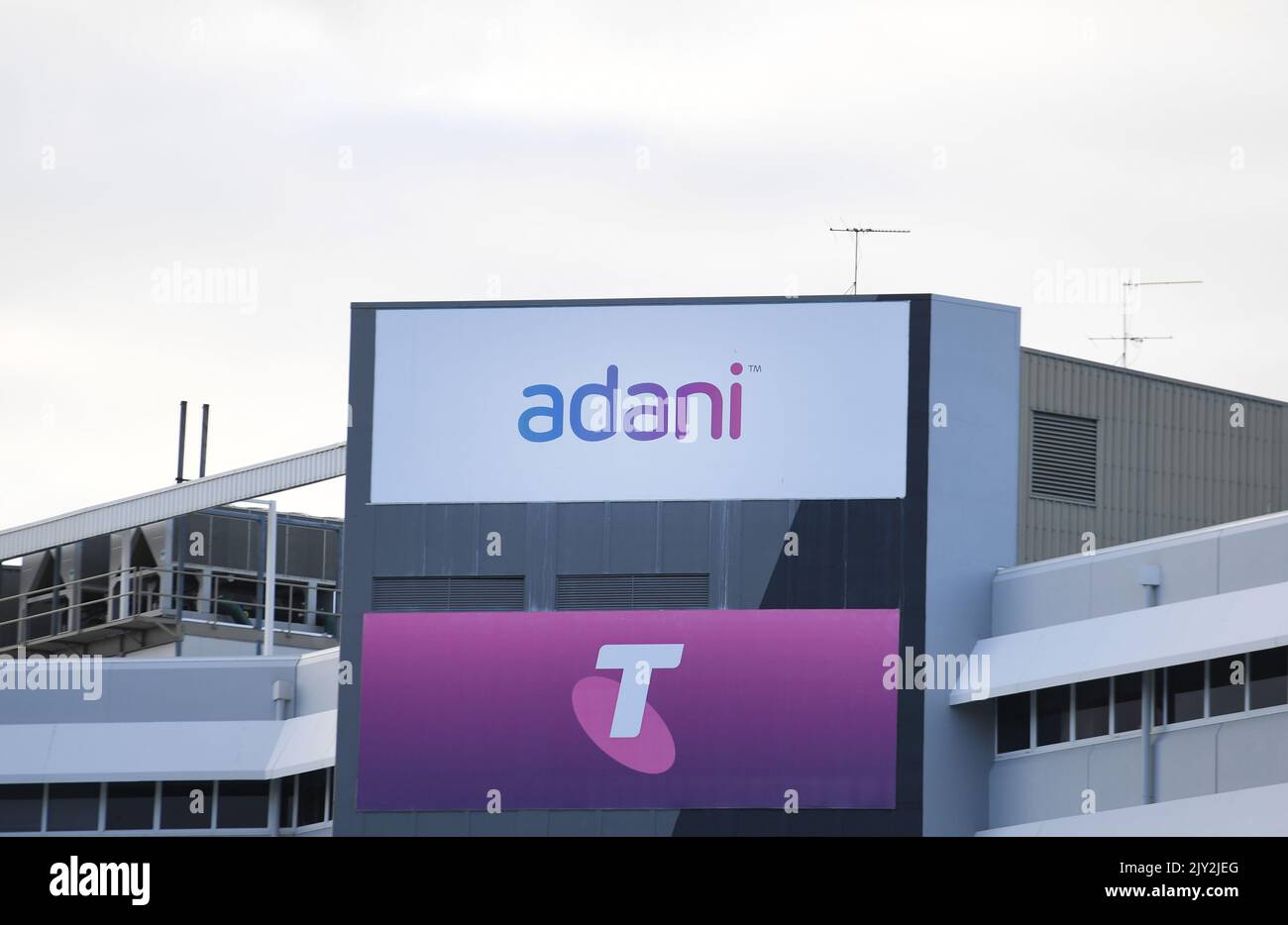 The Adani Mining logo (top) is seen on the company's office building in ...