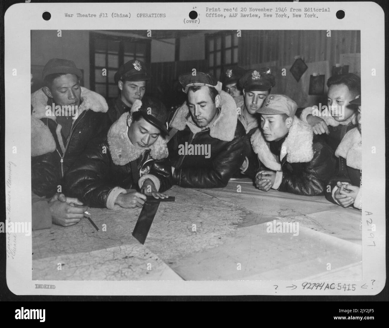 Chinese Pilot Plot A Course On A Briefing Table While Other Chinese And ...