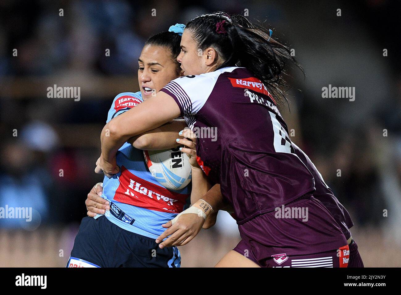 Corban McGregor of NSW is tackled by Amber Pilley of the Maroons during ...