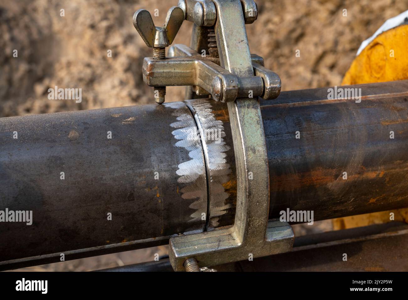 Laying of district heating pipes, next to a field, with maize, the district heating comes from a ...