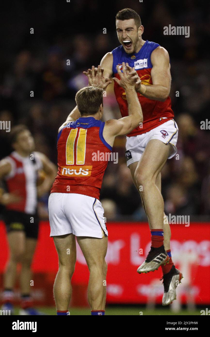 Daniel McStay of the Lions (right) celebrates a goal during the Round ...