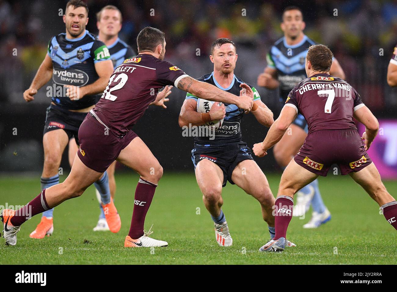 Damien Cook of the Blues is tackled by Matt Gillett (left) and Daly ...