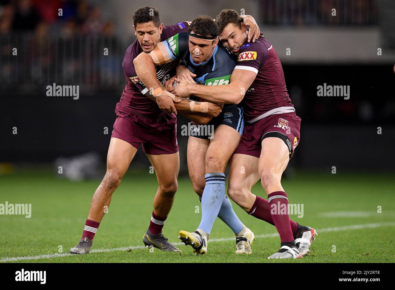 Dale Finucane of the Blues is tackled by Dane Gagai (left) and Corey ...