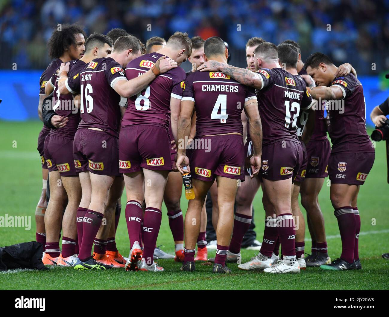 Queensland players are seen in a hurdle on full time after losing Game ...