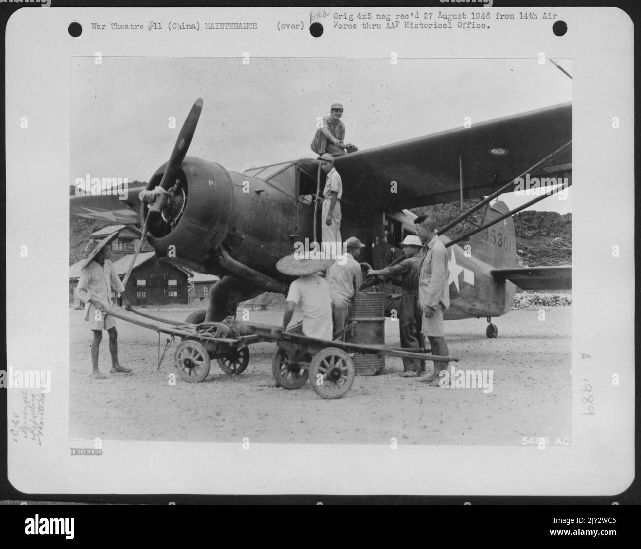 Chinese coolies help service a small plane at an advanced airbase of ...
