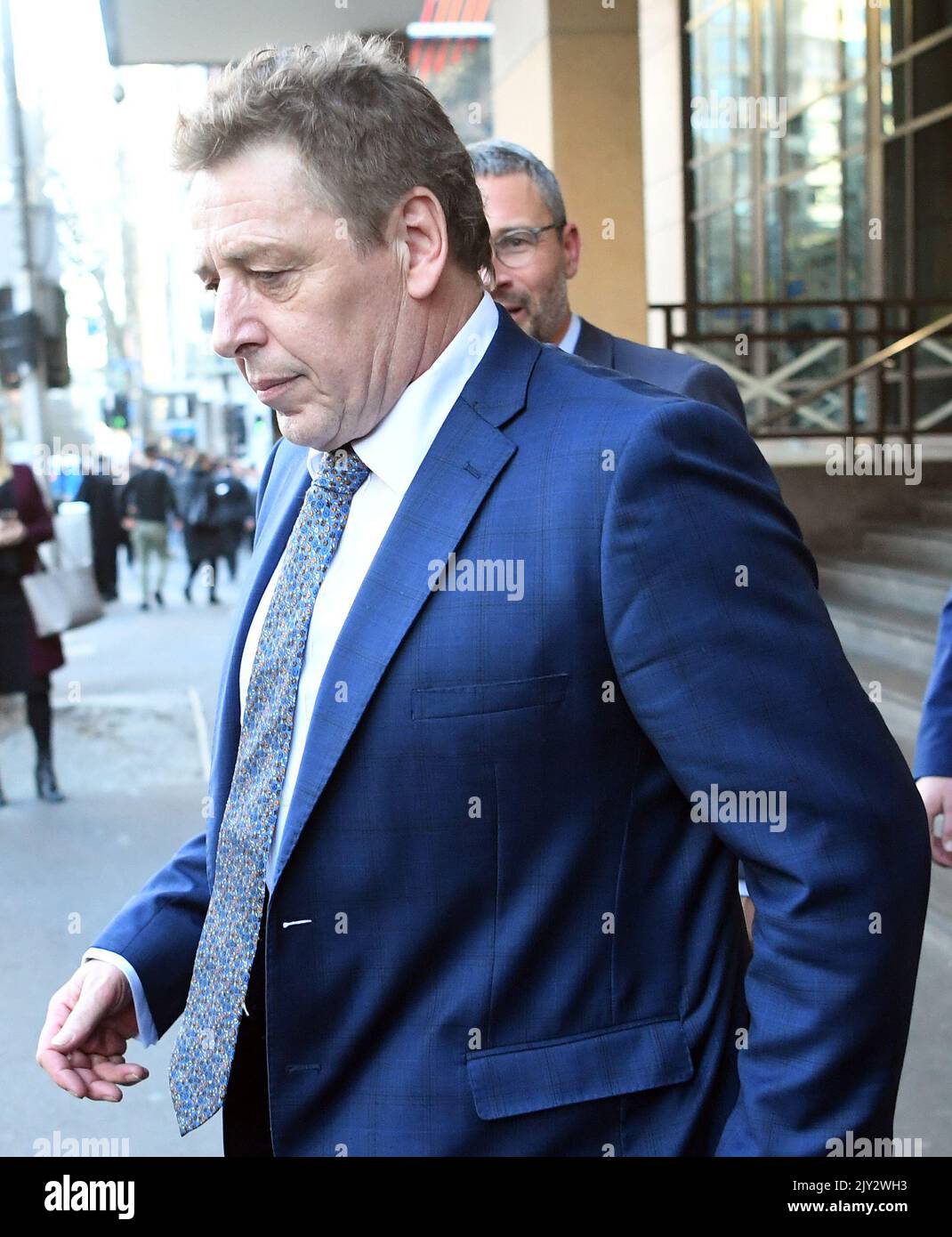 Former AFL player and coach Mark 'Bomber' Thompson (centre) leaves the ...